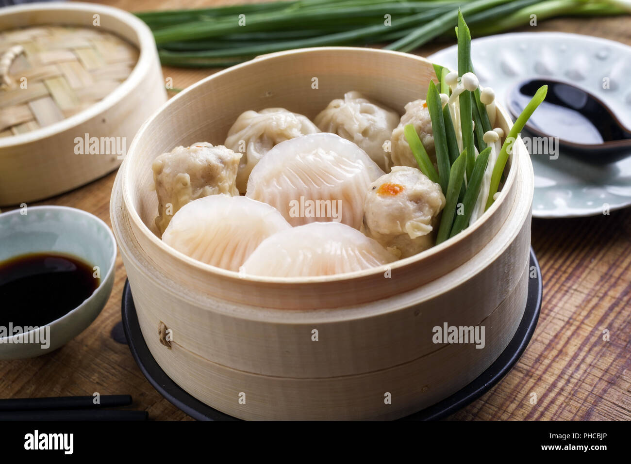 Traditional Chinese Dim Sum as close-up on Bamboo Steamer Stock Photo ...