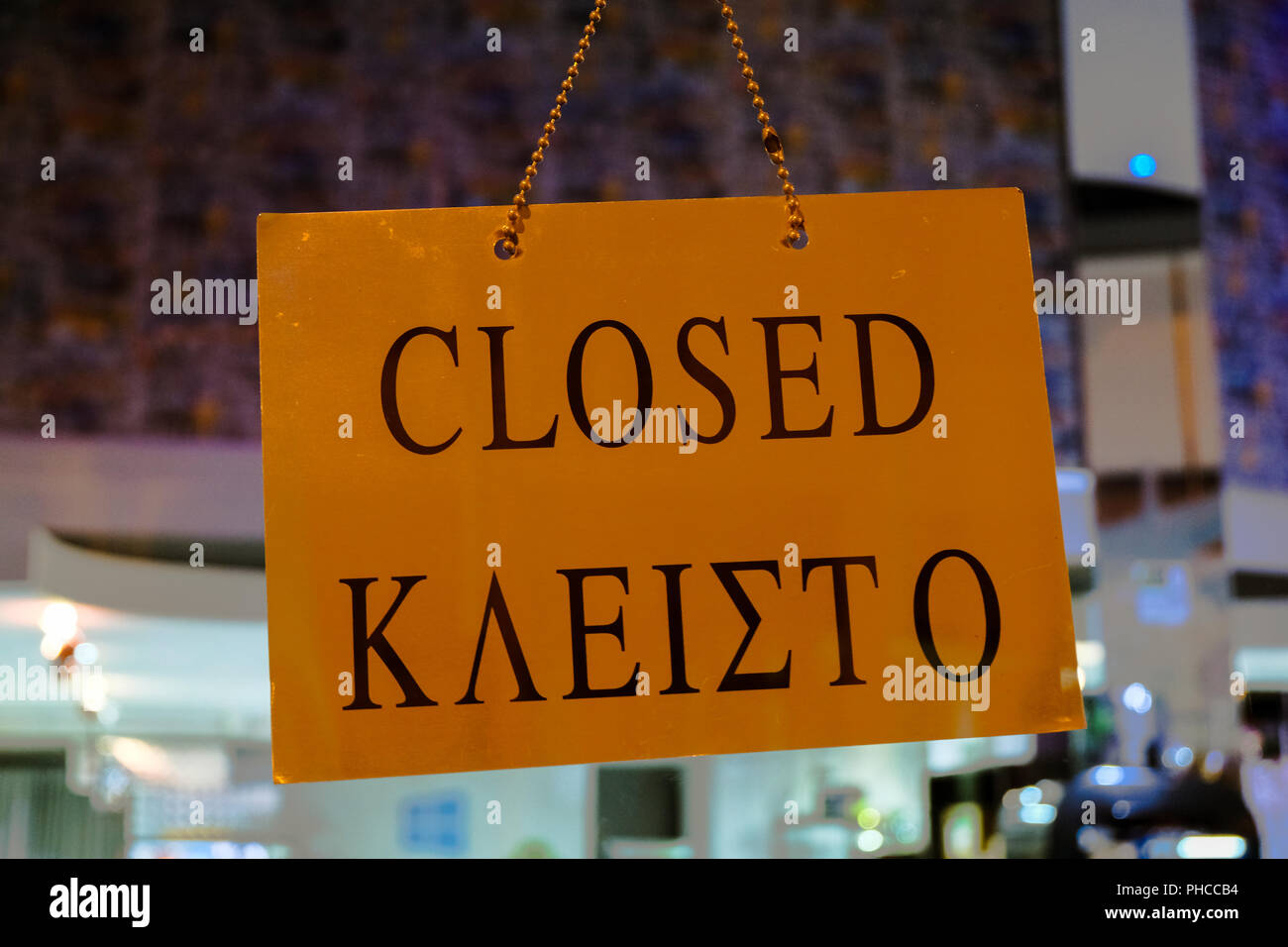 Closed sign board hanging on the glass of a store window in Larnaca ...