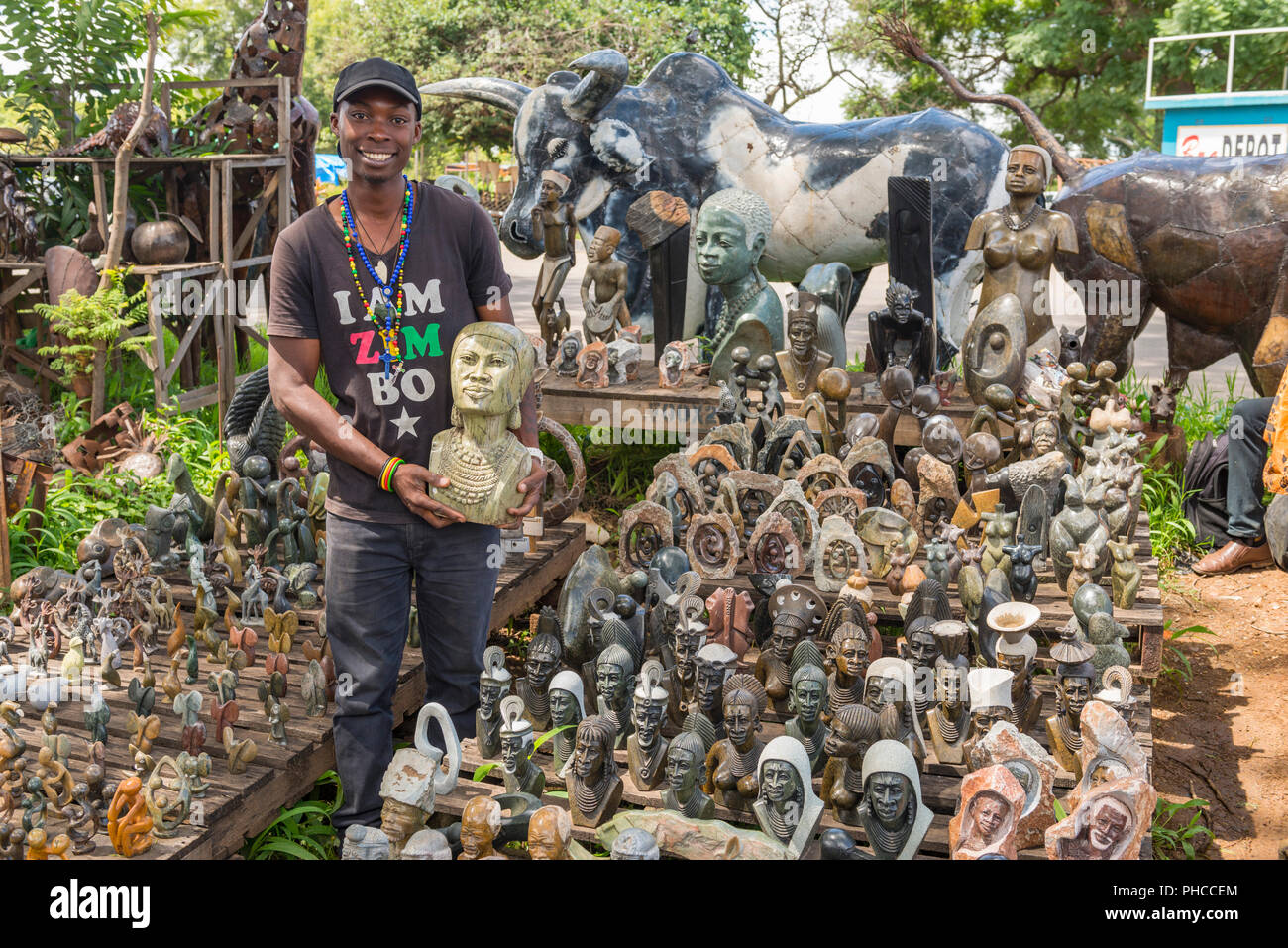 A curio seller holds up a stone carving in Harare Zimbabwe Stock Photo ...