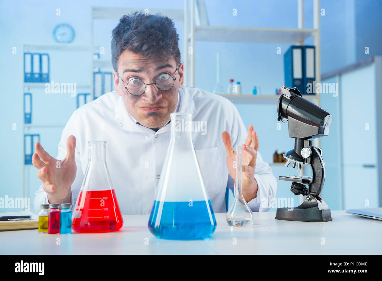 Funny mad chemist working in a laboratory Stock Photo - Alamy