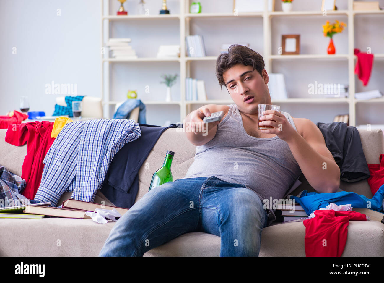 Young man student drunk drinking alcohol in a messy room Stock Photo ...