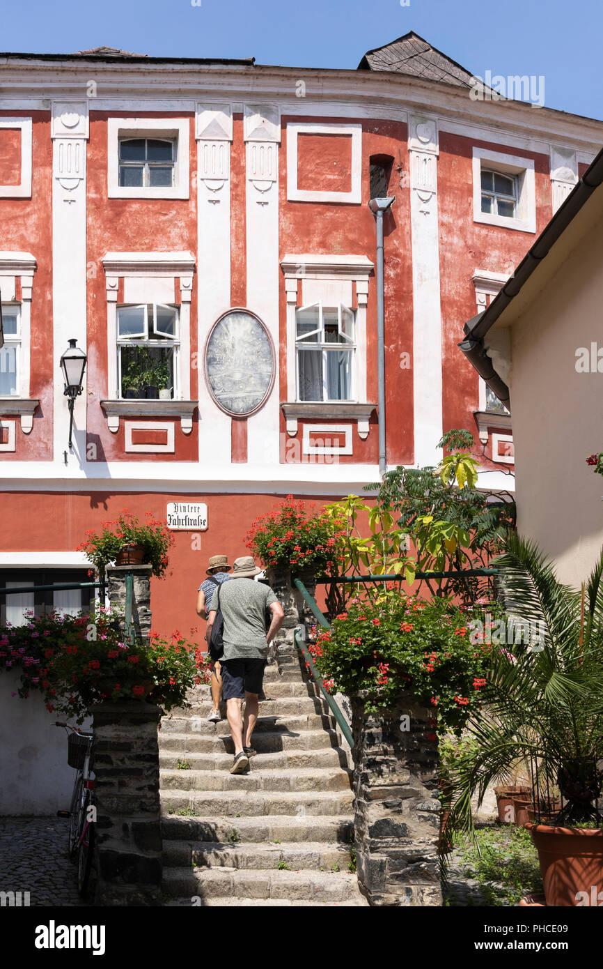 A tourist climbing steps to the Hintere Fahrstraße, in the old town of ...