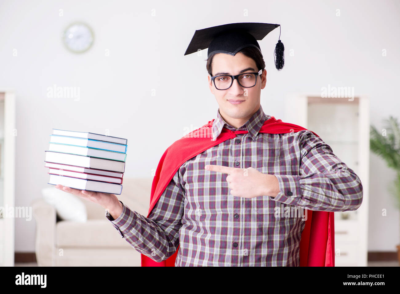 Super hero student with books studying for exams Stock Photo - Alamy