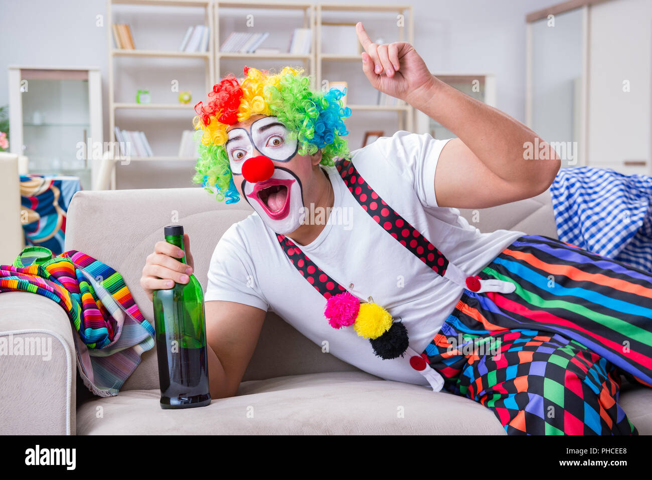 Drunk clown celebrating having a party at home Stock Photo - Alamy