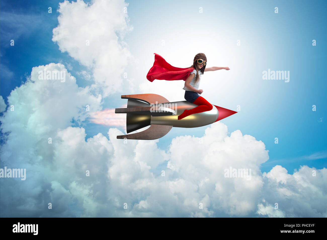 Little girl flying rocket in superhero concept Stock Photo - Alamy