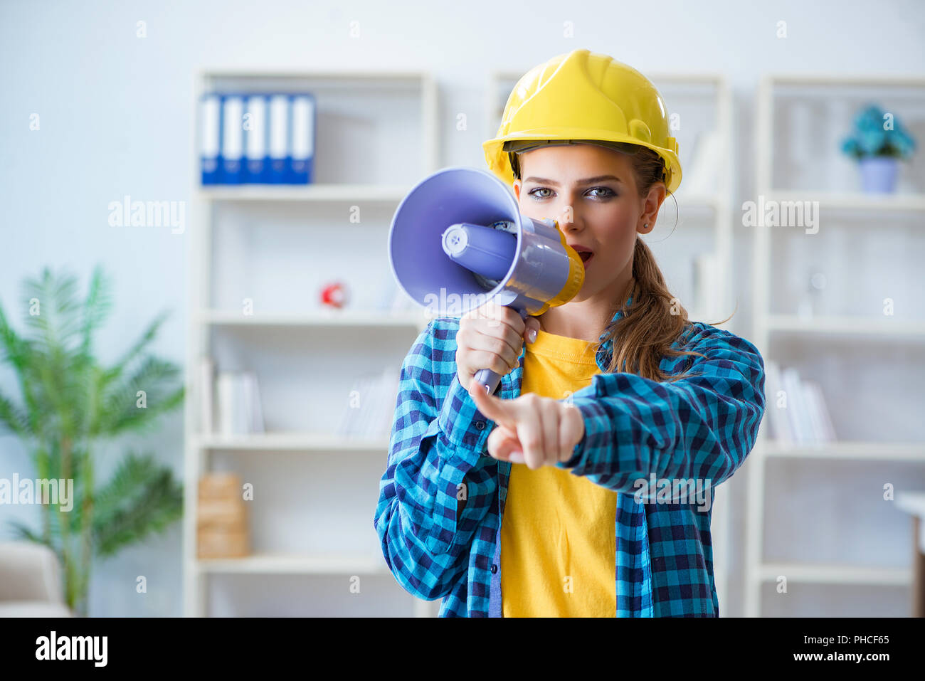 Angry building supervisor with megaphone Stock Photo - Alamy