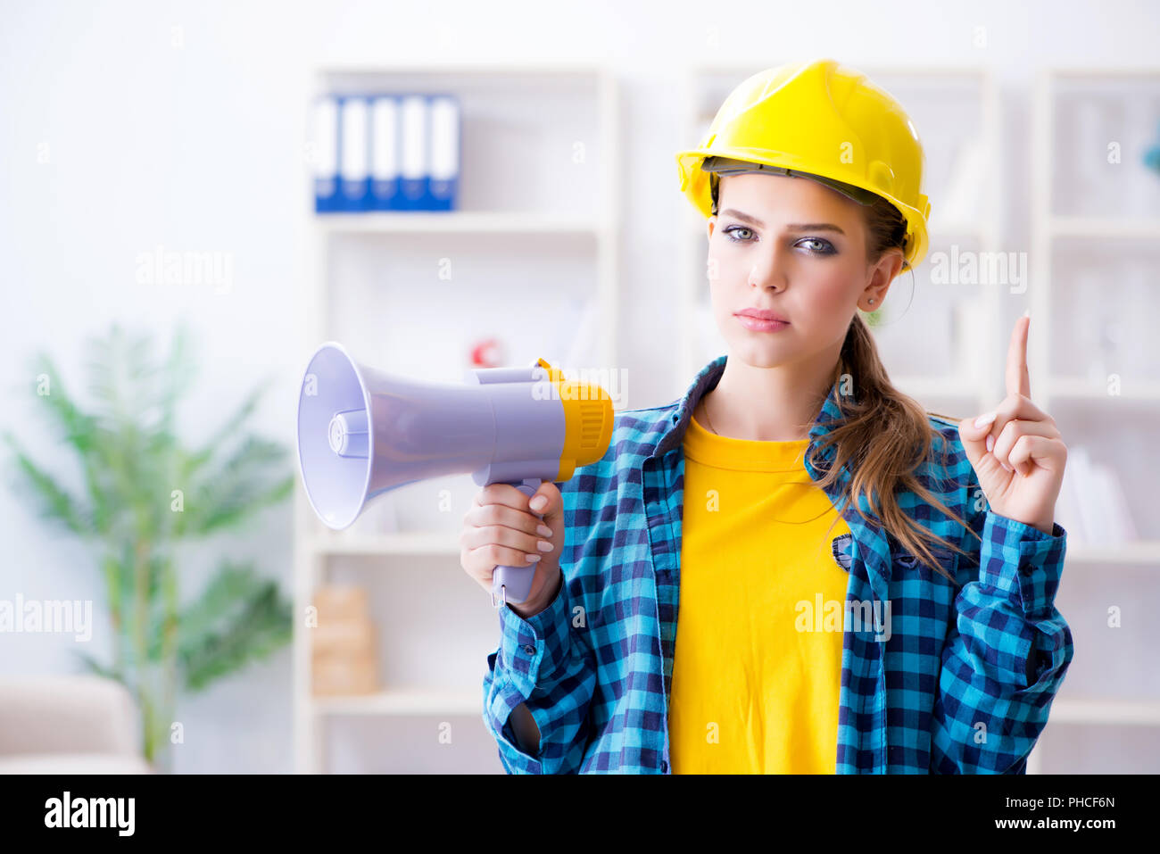 Angry building supervisor with megaphone Stock Photo - Alamy