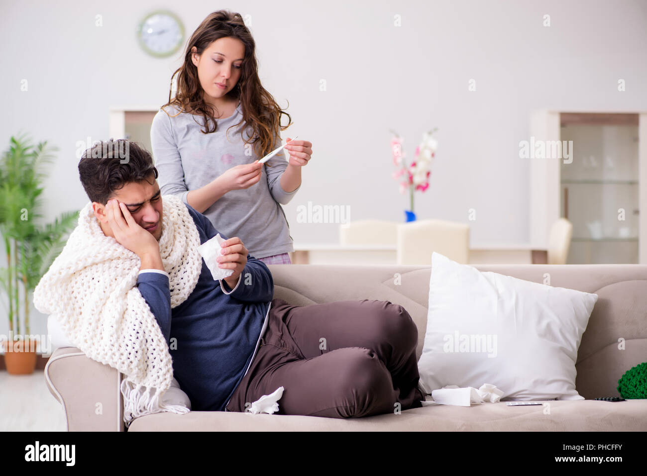 Wife caring for sick husband at home Stock Photo - Alamy