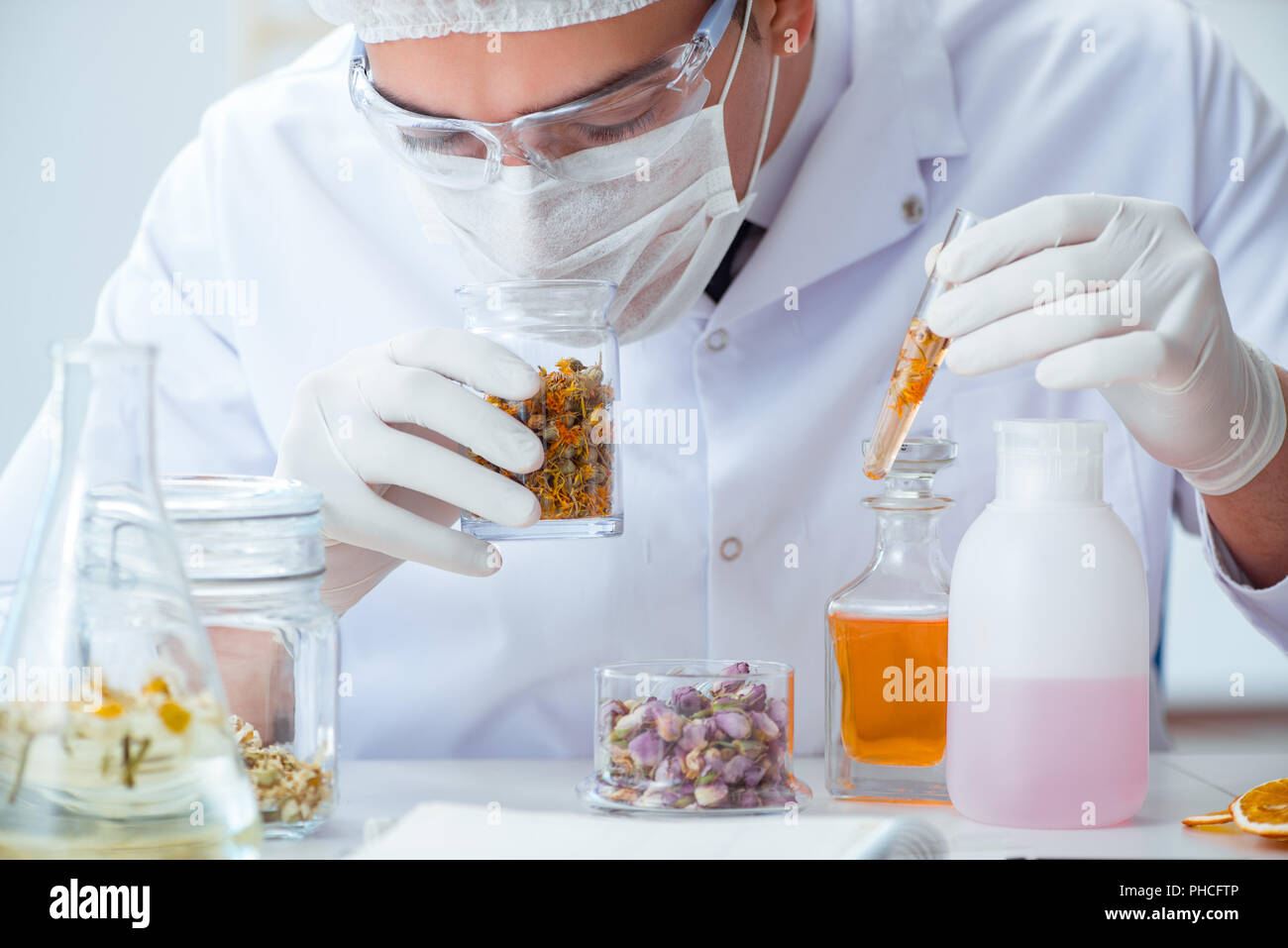 Chemist mixing perfumes in the lab Stock Photo - Alamy