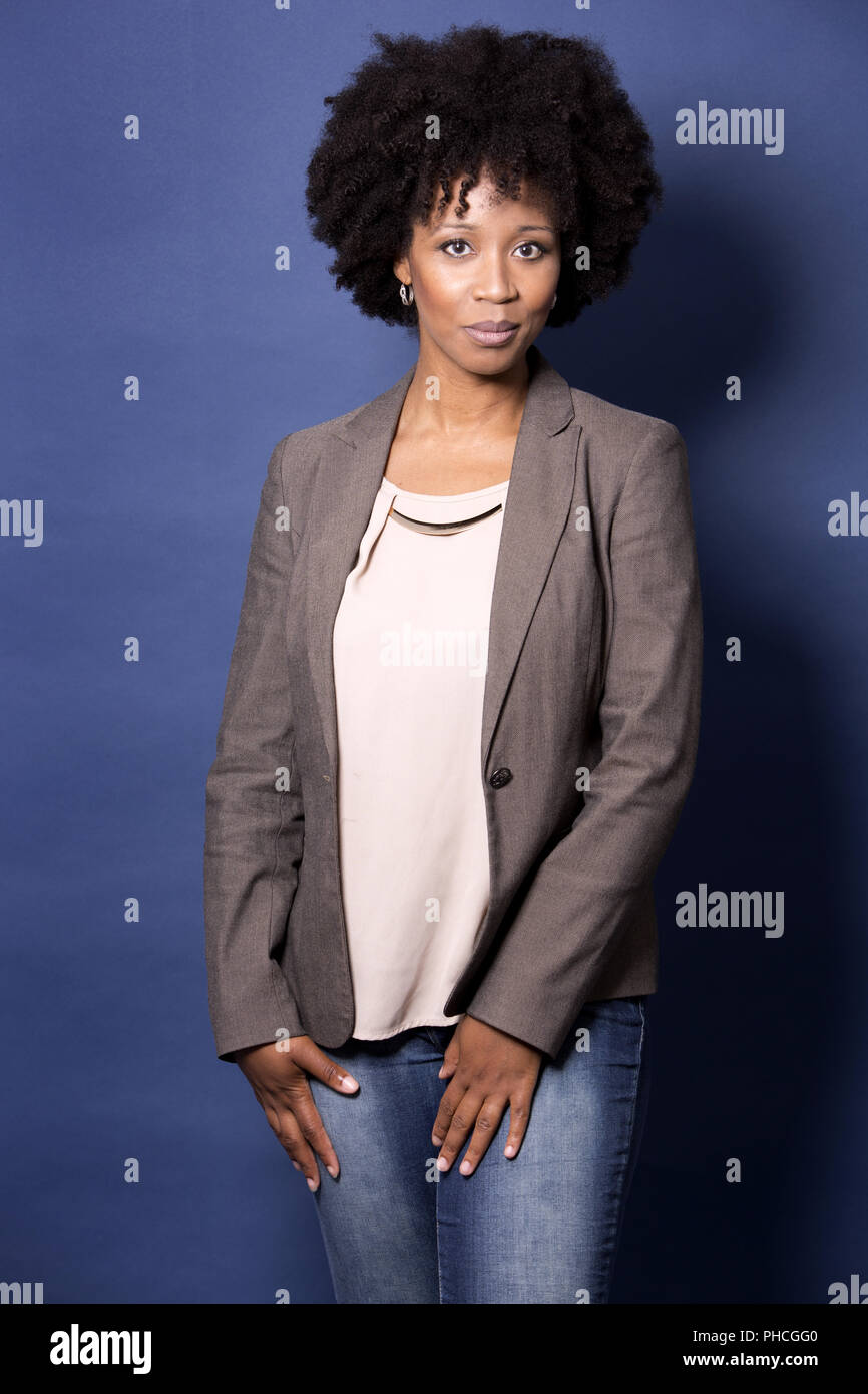 Black woman blue background hi-res stock photography and images - Alamy