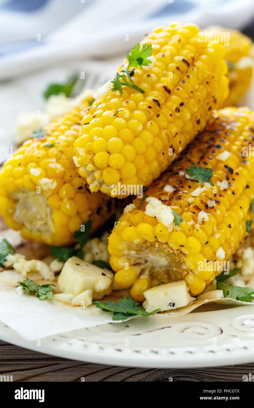 Sweet corn grilled with cheese and cilantro Stock Photo - Alamy