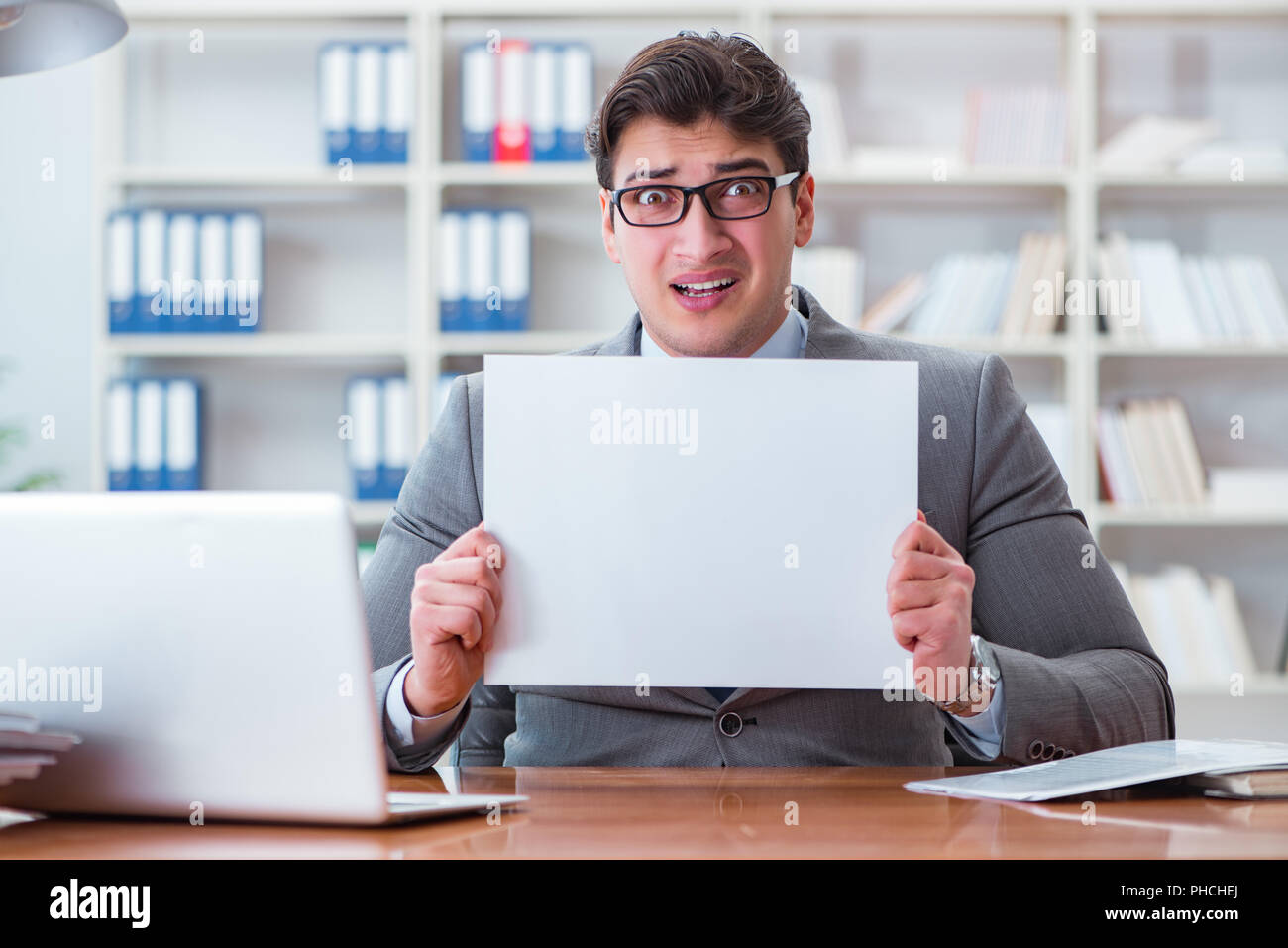 The businessman in office holding a blank message board Stock Photo - Alamy