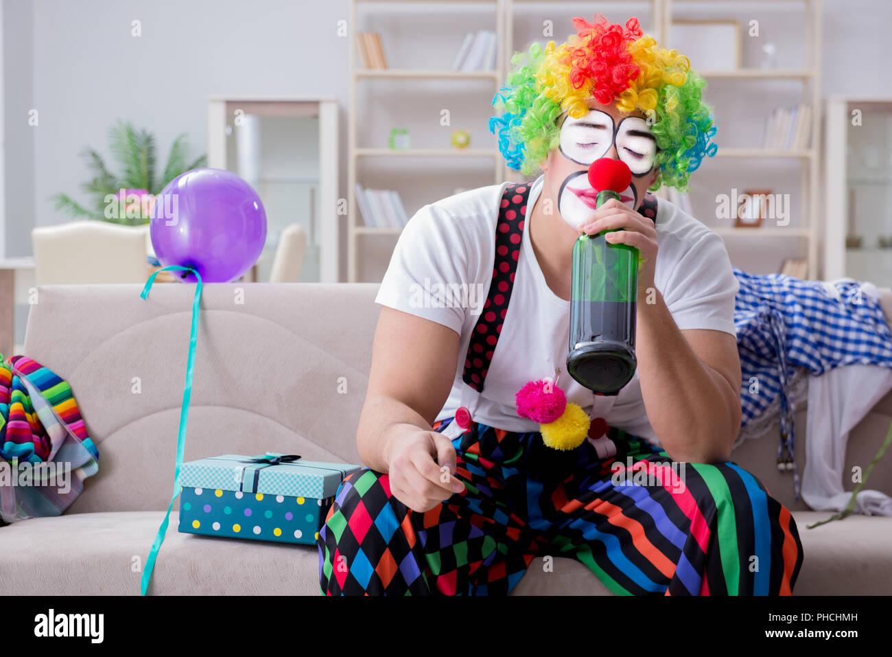 The drunk clown celebrating having a party at home Stock Photo - Alamy