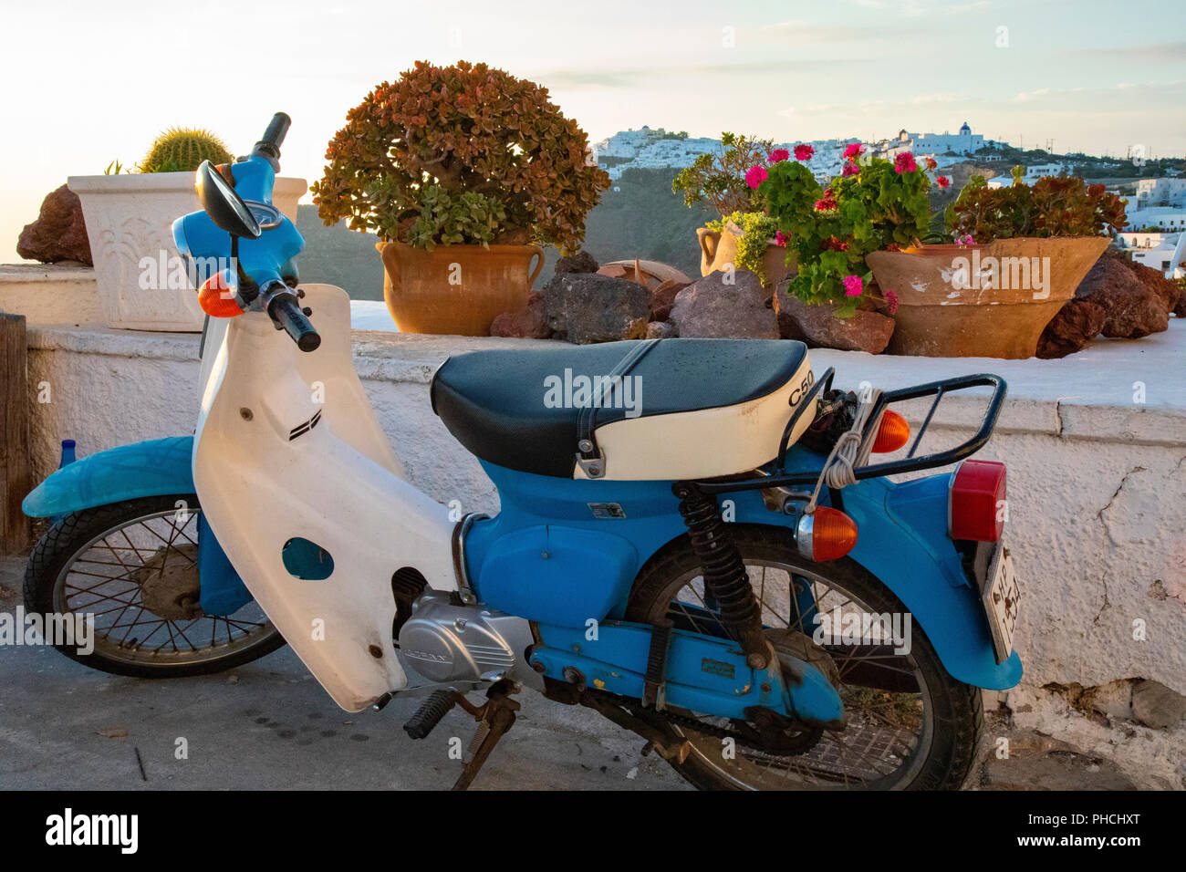 Blue and white Scooter moped parked at senic overlook in Fira Santorini ...