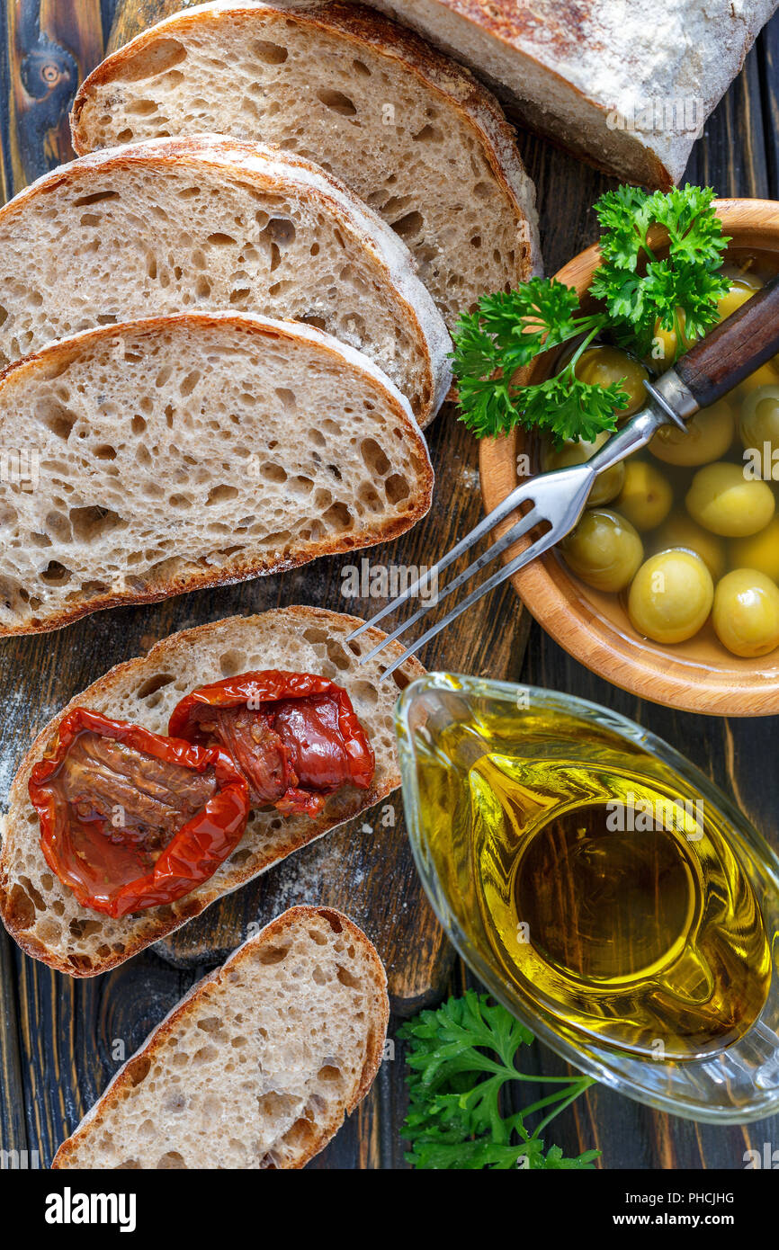Fresh ciabatta, olives, oil and sun-dried tomatoes Stock Photo - Alamy