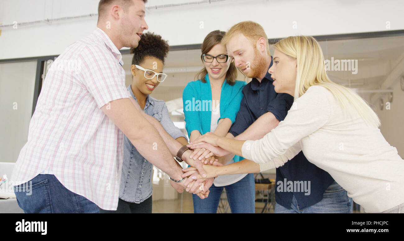 People stacking hands for team Stock Photo - Alamy