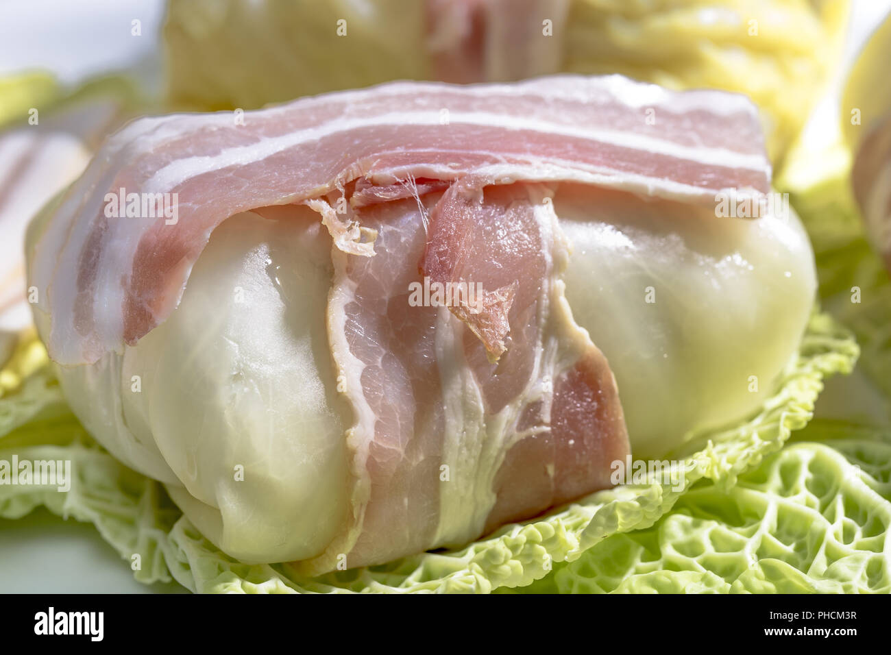 Preparation of savoy roulade with bacon on cabbage leaves Stock Photo ...