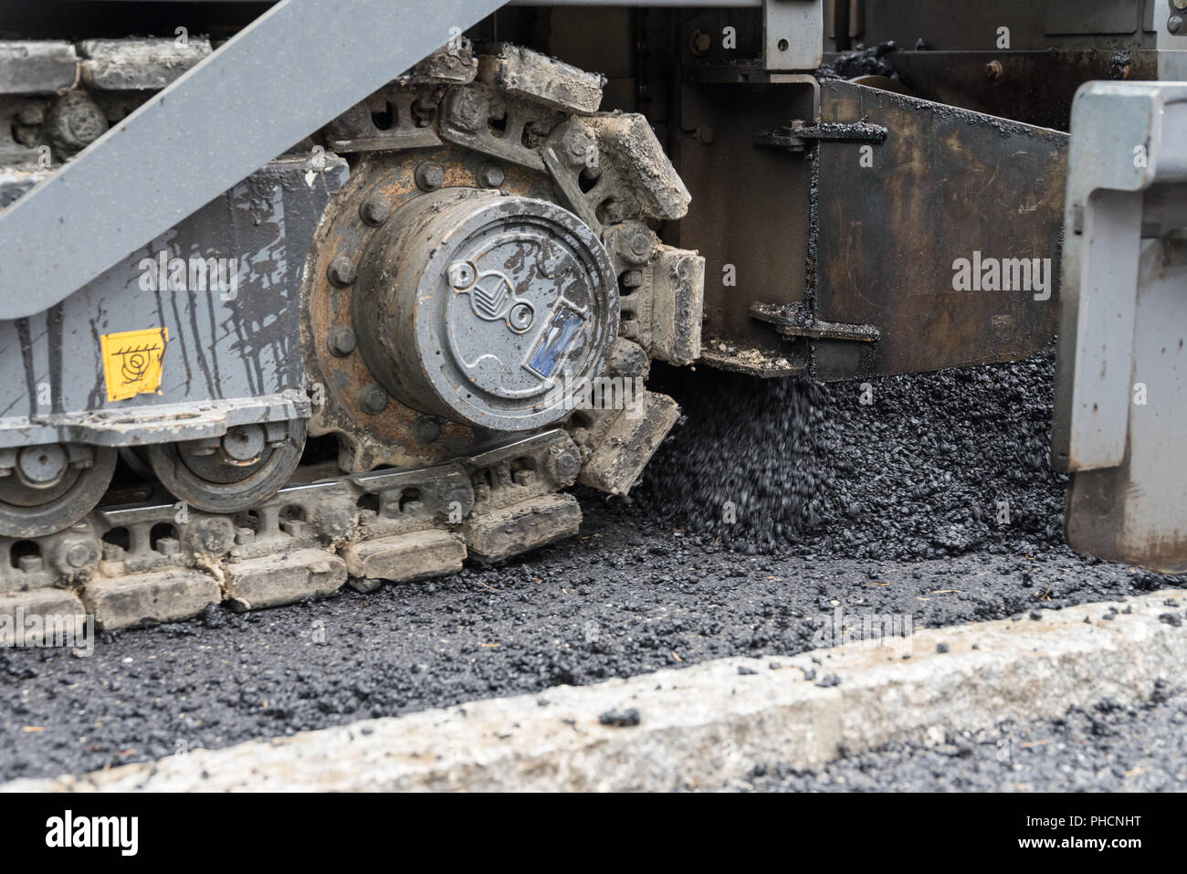 Track paver in road construction - closeup Stock Photo - Alamy