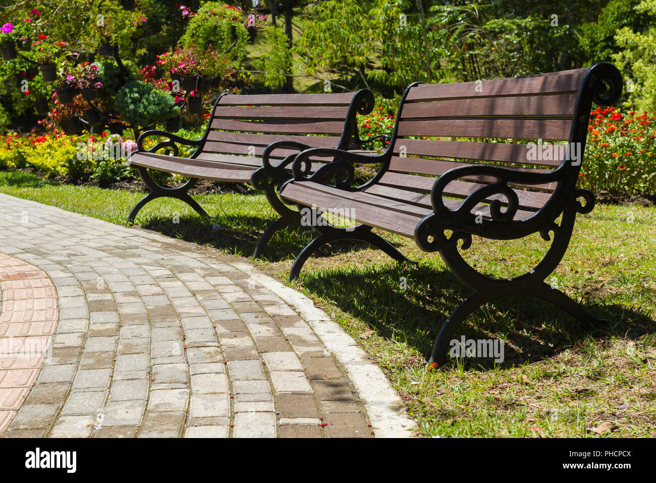 two rustic chairs next to the path in a beautiful parcel Stock Photo ...