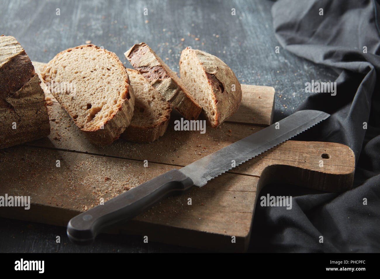 Sliced bread on wooden board Stock Photo - Alamy