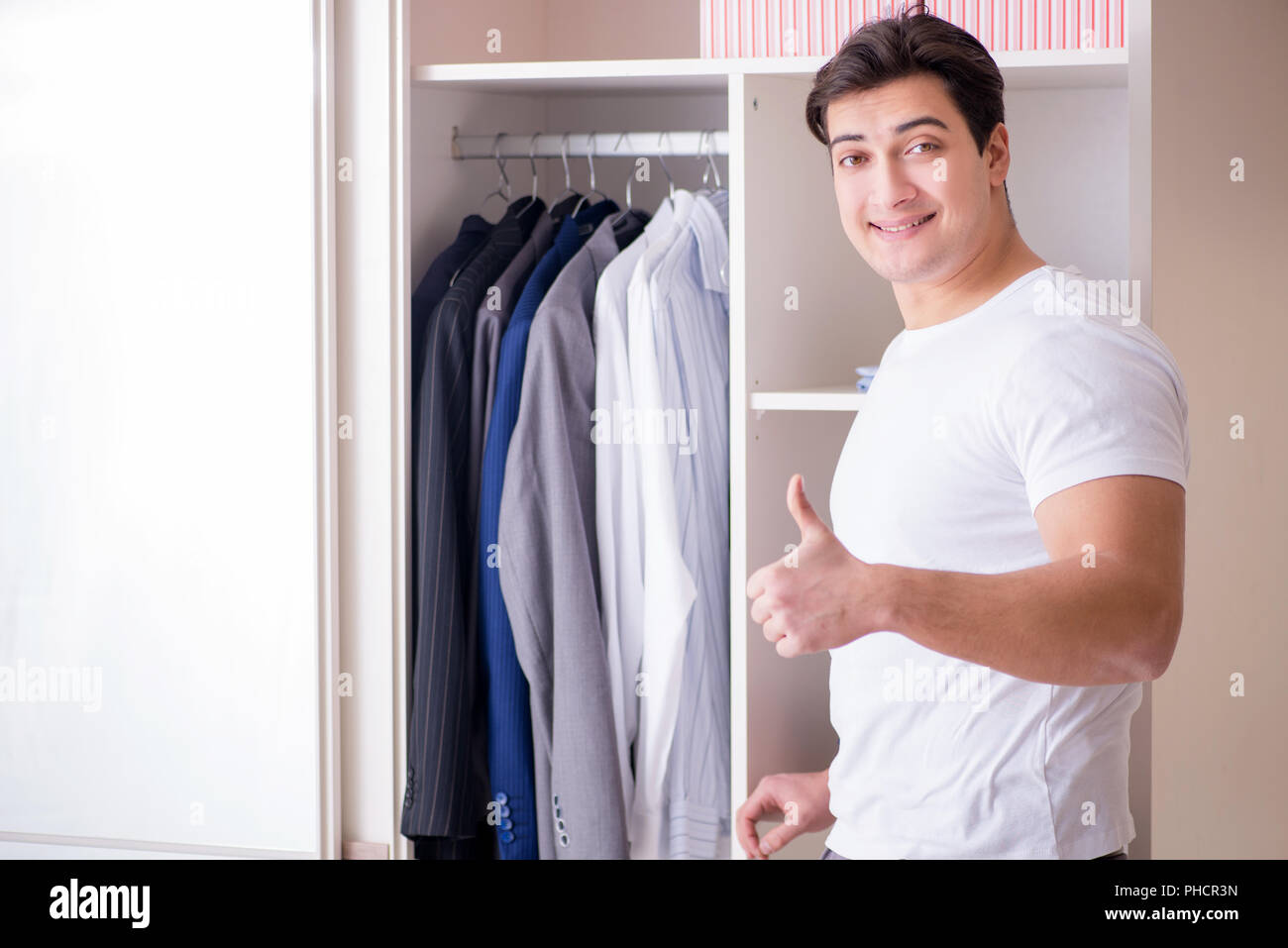 Young man businessman getting dressed for work Stock Photo - Alamy