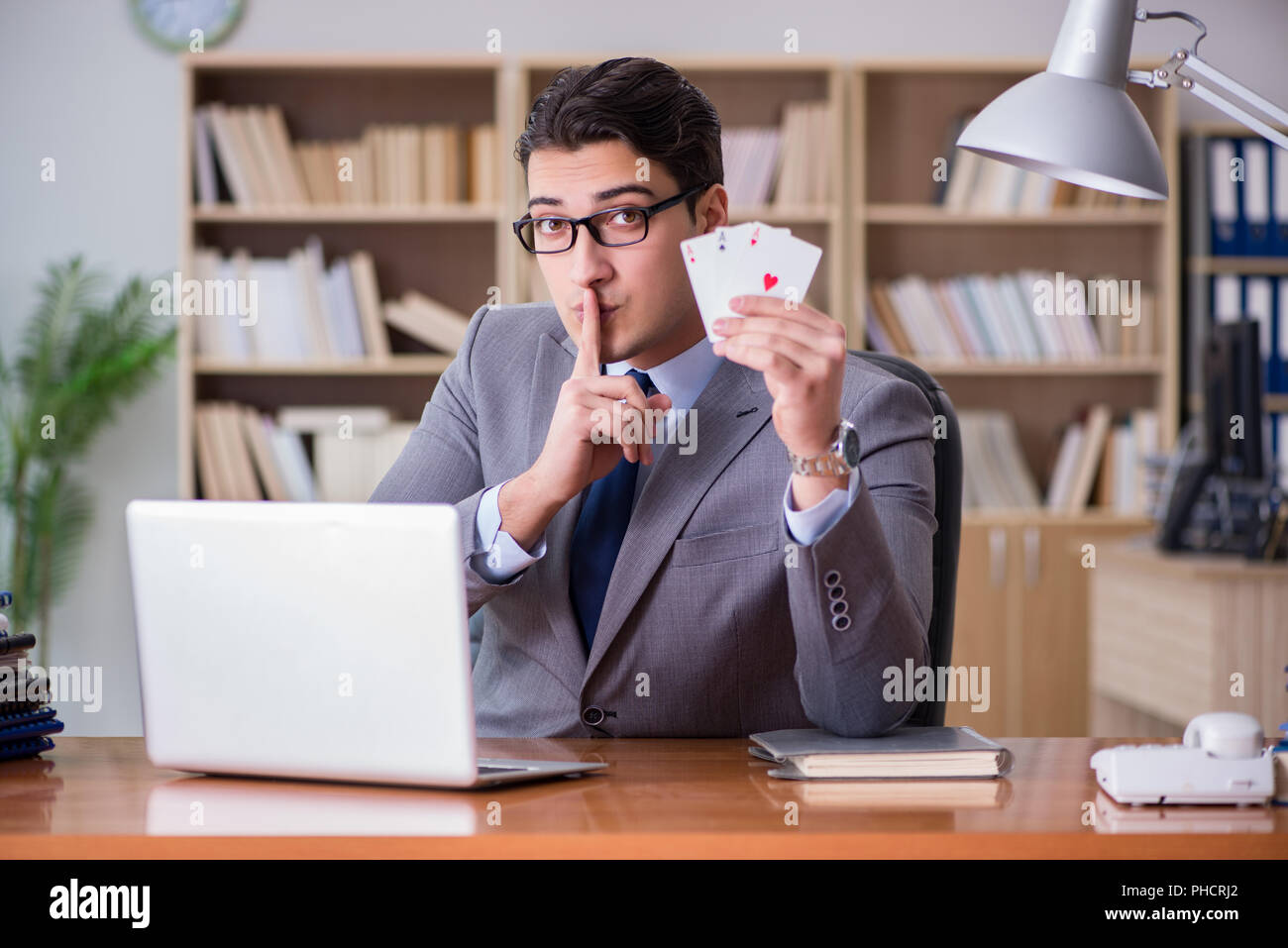 Businessman gambling playing cards at work Stock Photo - Alamy