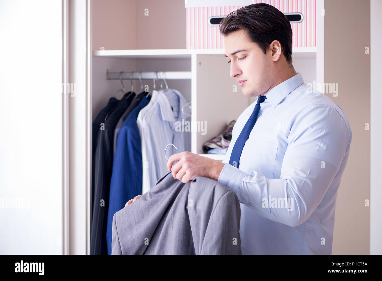 Young man businessman getting dressed for work Stock Photo - Alamy