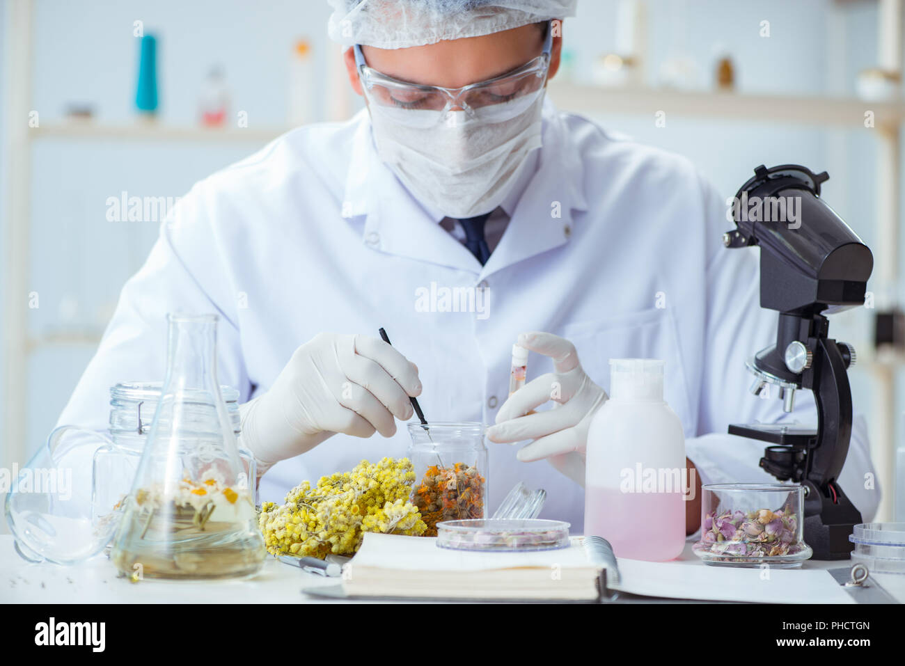 Chemist mixing perfumes in the lab Stock Photo - Alamy
