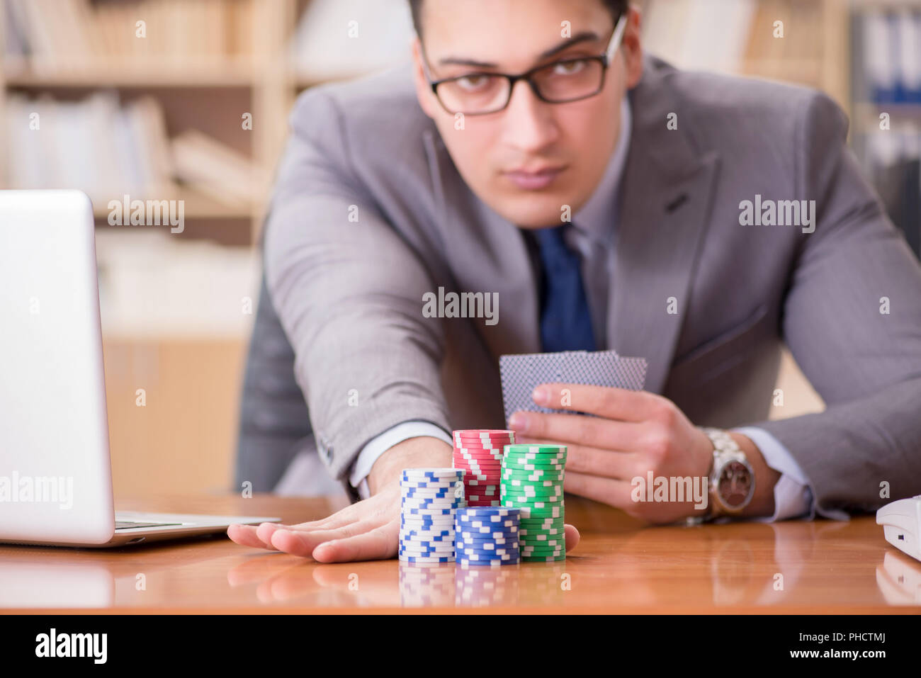 Businessman gambling playing cards at work Stock Photo - Alamy