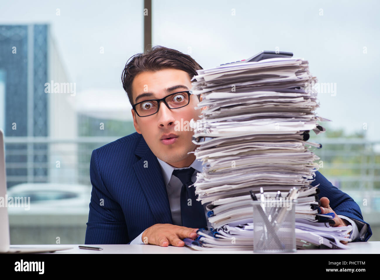 Businessman with pile stack of paper paperwork in the office Stock ...
