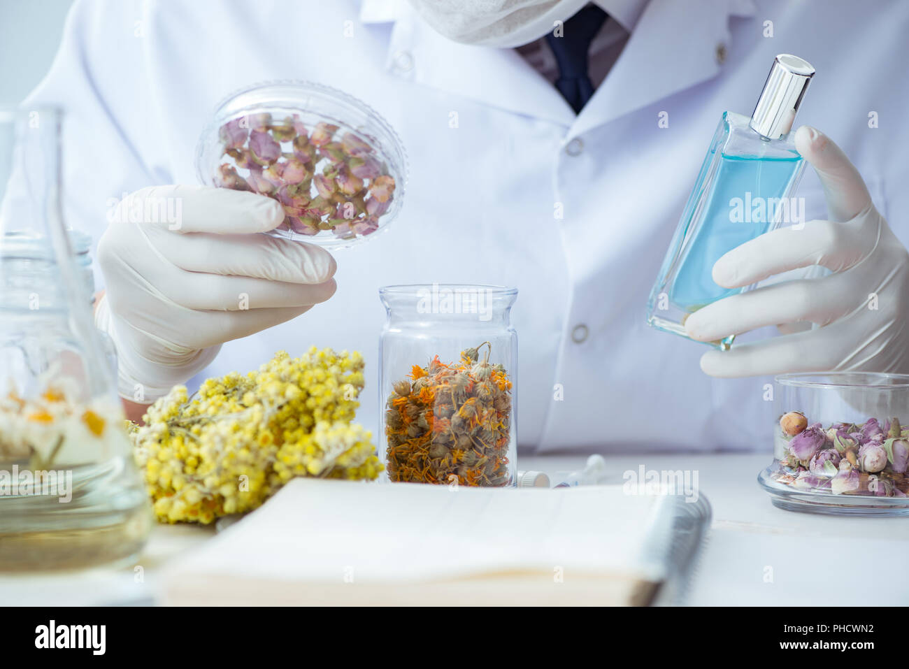 Chemist mixing perfumes in the lab Stock Photo - Alamy