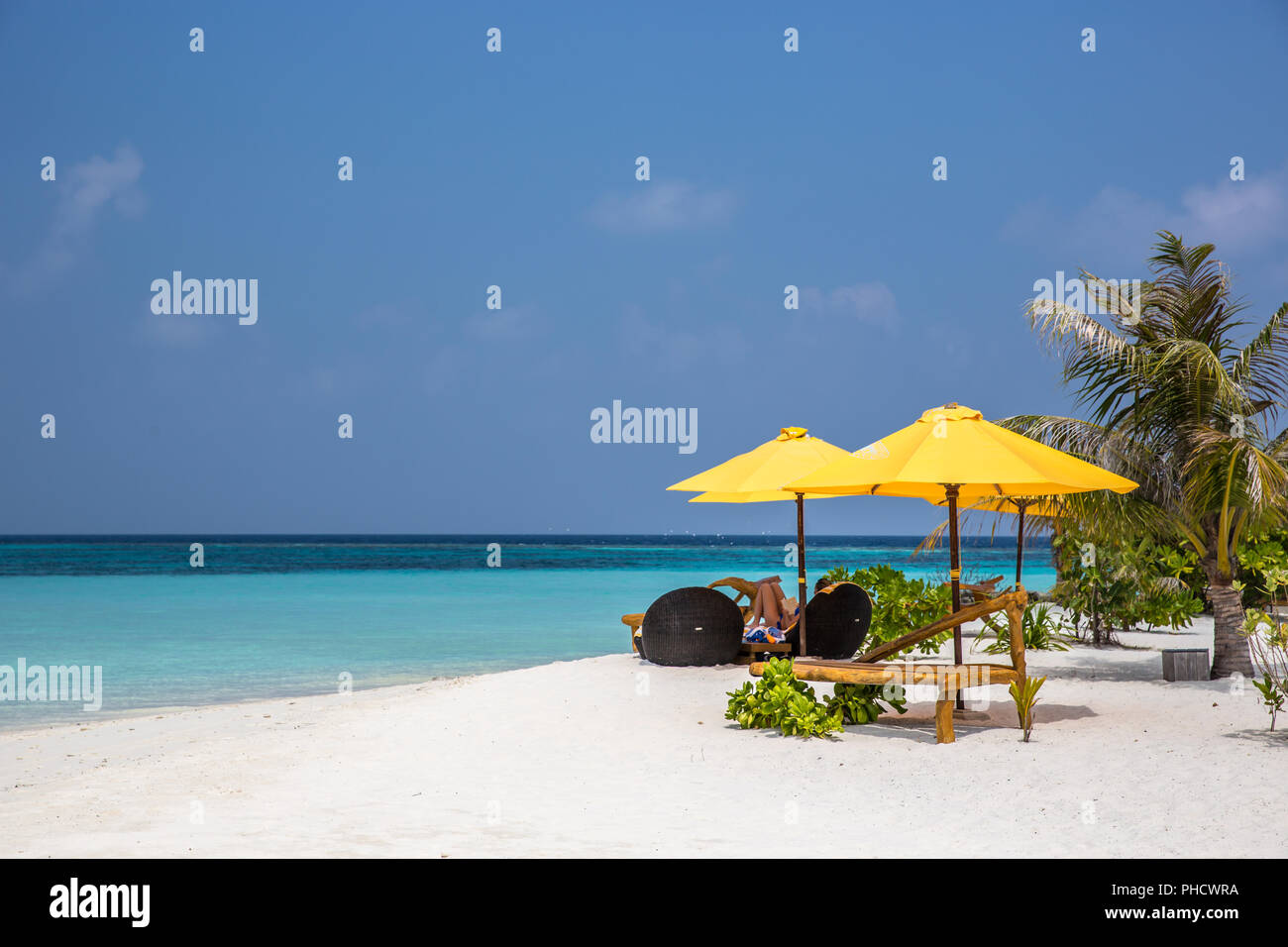 Amazing beach, yellow beach umbrella, blue sky, concept of paradise ...