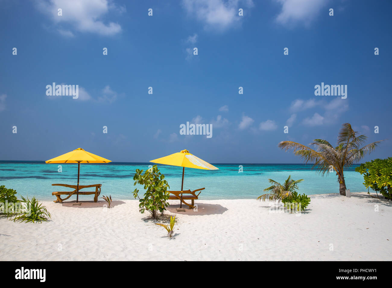 Amazing beach, yellow beach umbrella, blue sky, concept of paradise ...