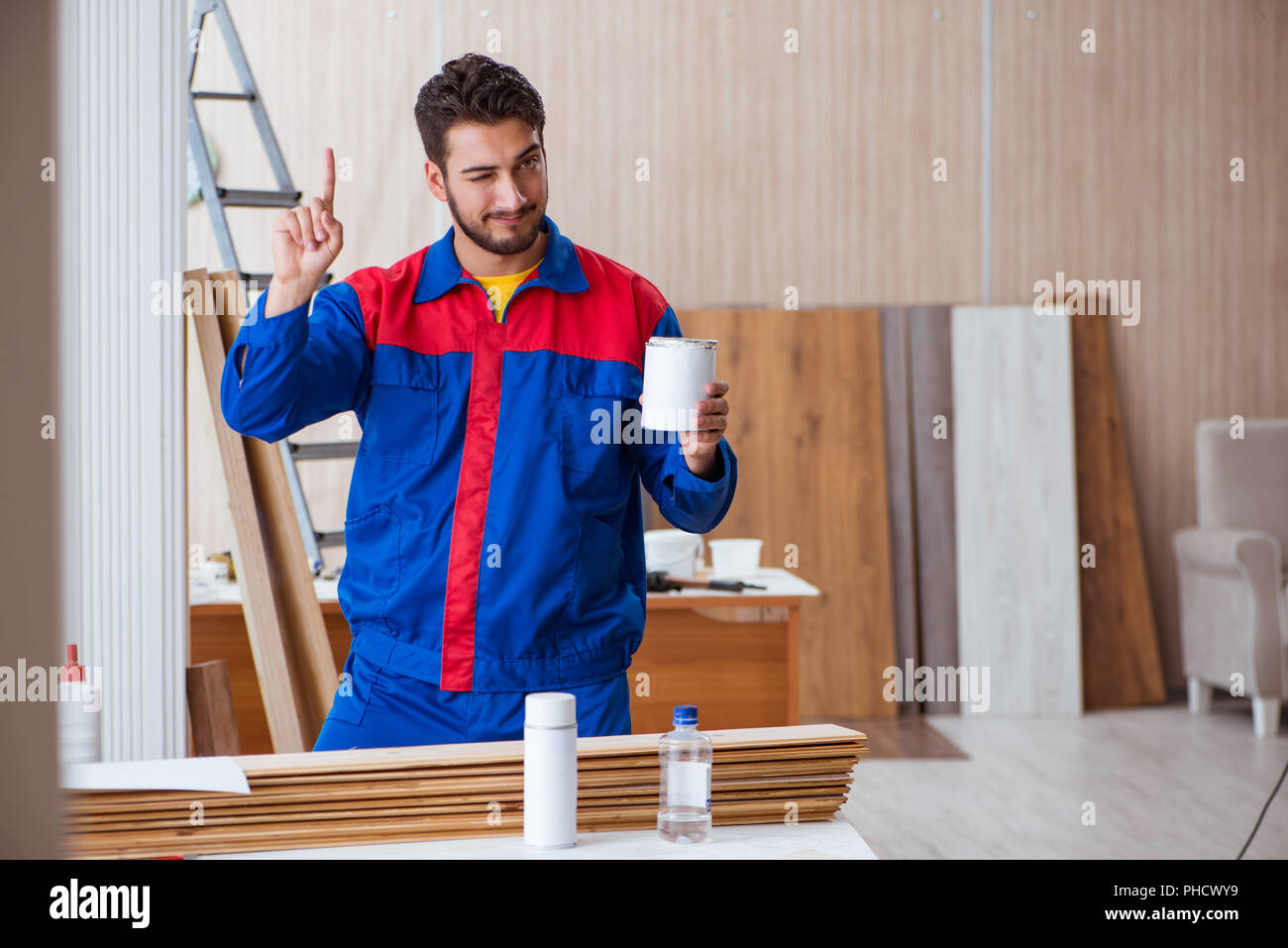 Yooung repairman carpenter working with paint painting Stock Photo - Alamy