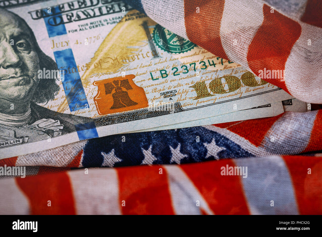 American flag on assorted banknotes of US paper currency Stock Photo ...
