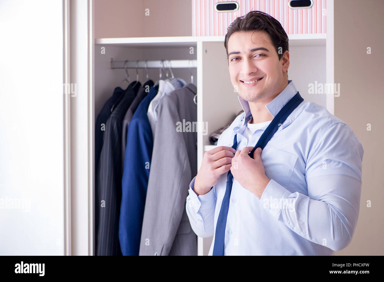Young man businessman getting dressed for work Stock Photo - Alamy