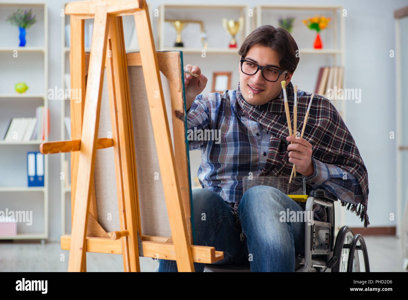Disabled artist painting picture in studio Stock Photo - Alamy