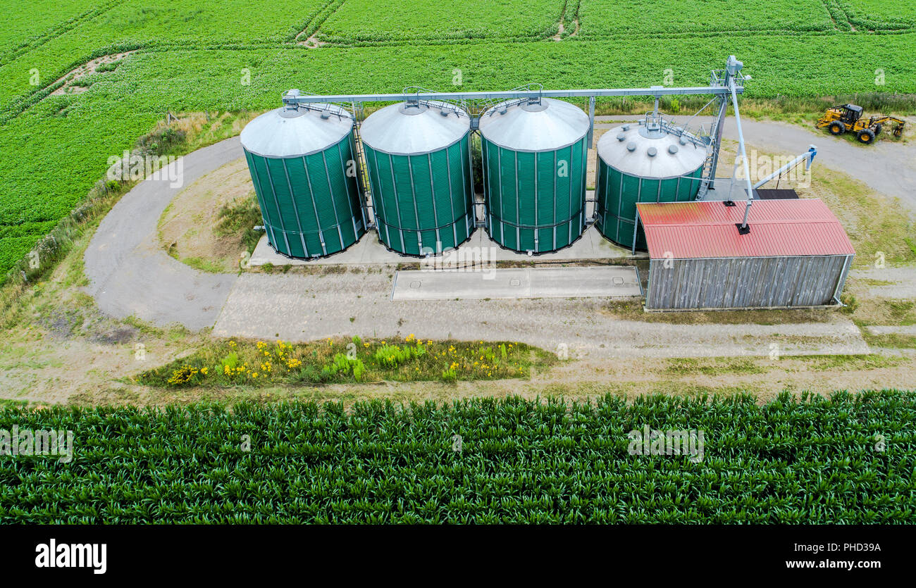 Silos in a field for storing grain, aerial view Stock Photo - Alamy