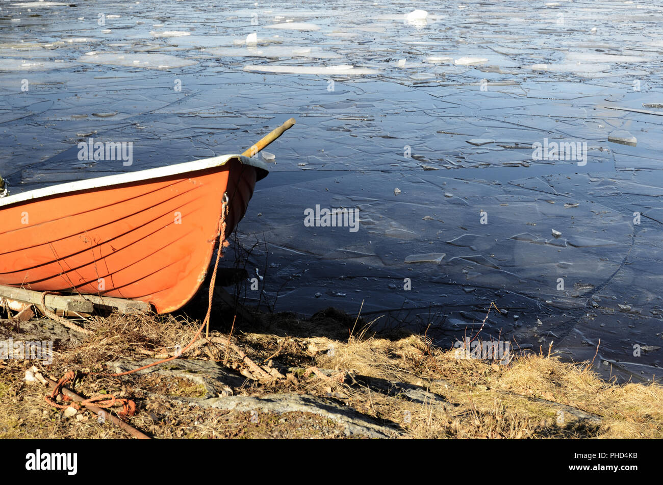 orange rescue boat on the shore of a frozen lake Stock Photo - Alamy