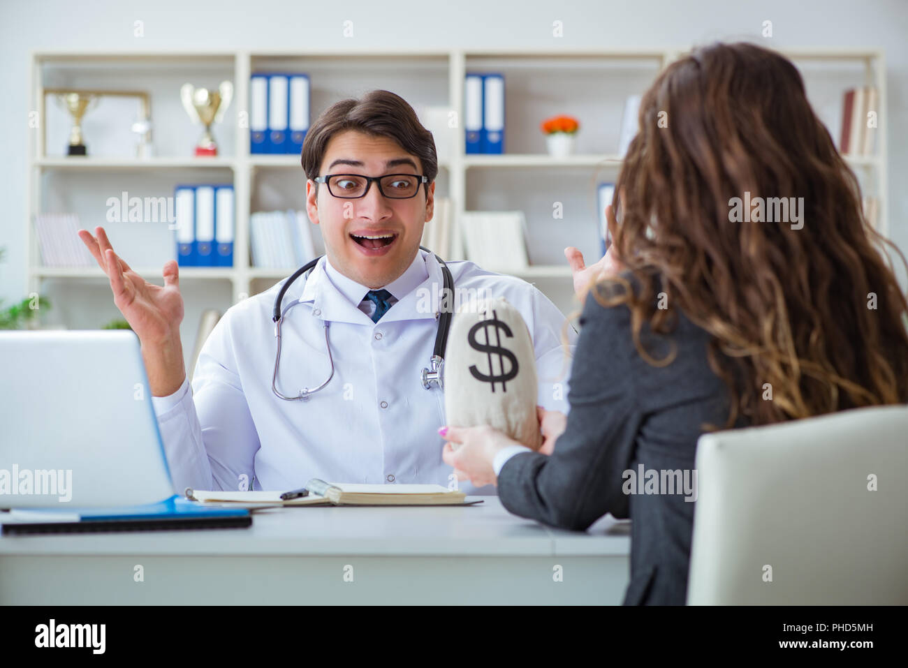 Young doctor in medical insurance fraud concept Stock Photo - Alamy
