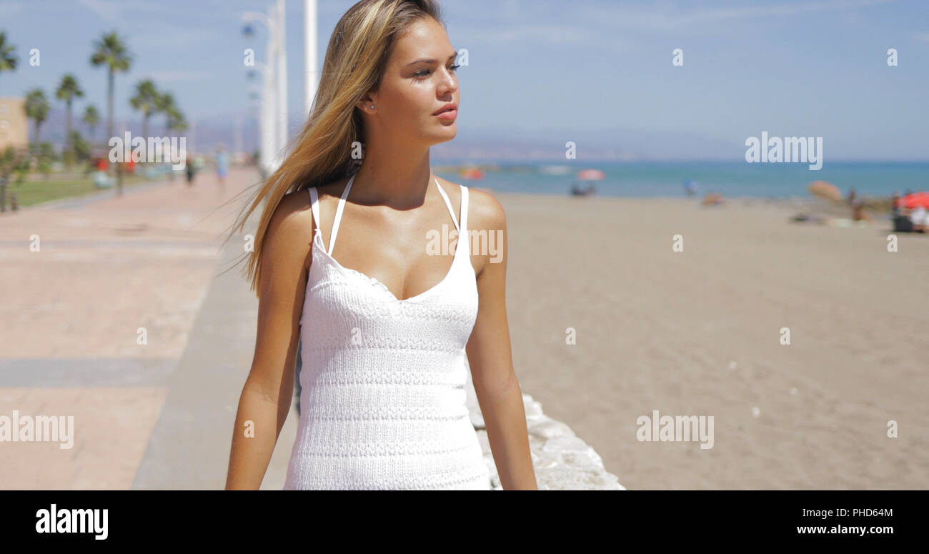 Confident model walking on beach Stock Photo - Alamy