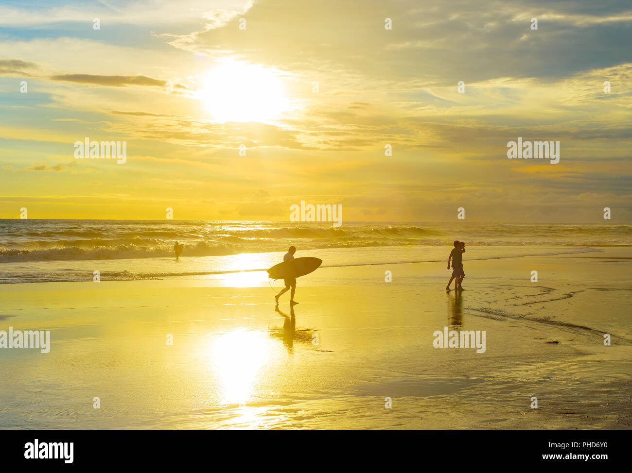 Surfer with surfboard, tropical beach Stock Photo - Alamy