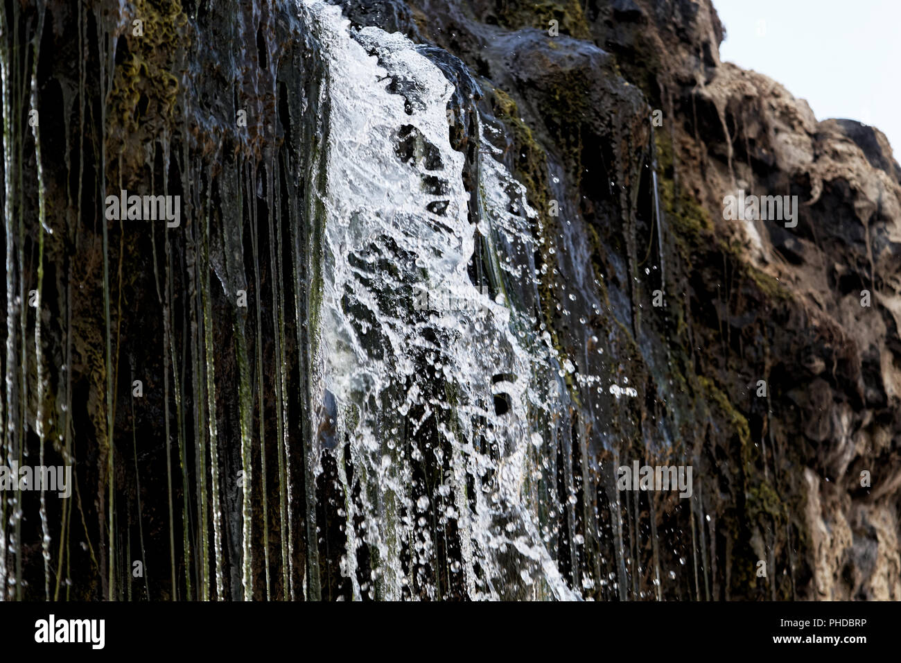 Detail of water flowing through a small waterfall Stock Photo - Alamy