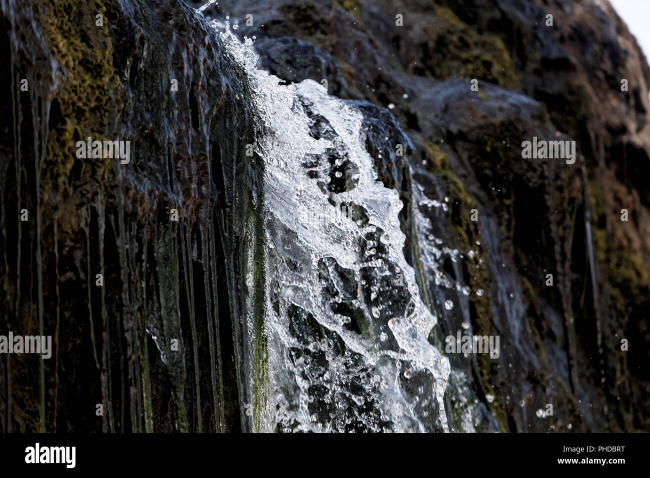 Detail of water flowing through a small waterfall Stock Photo - Alamy