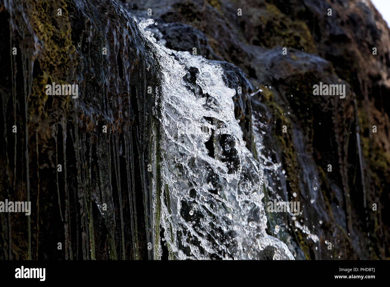 Detail of water flowing through a small waterfall Stock Photo - Alamy