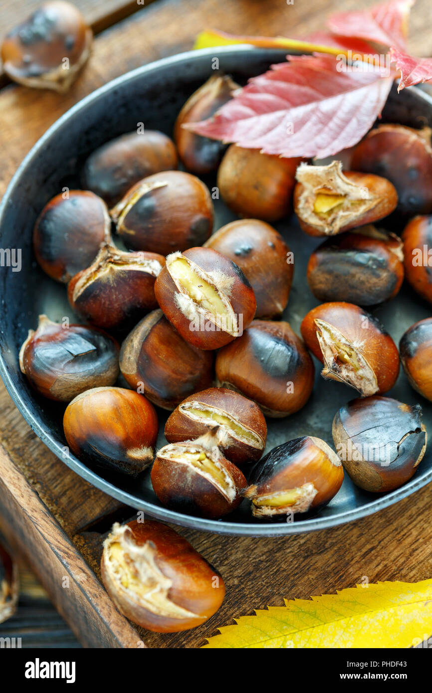 Roast chestnuts in a pan closeup Stock Photo - Alamy