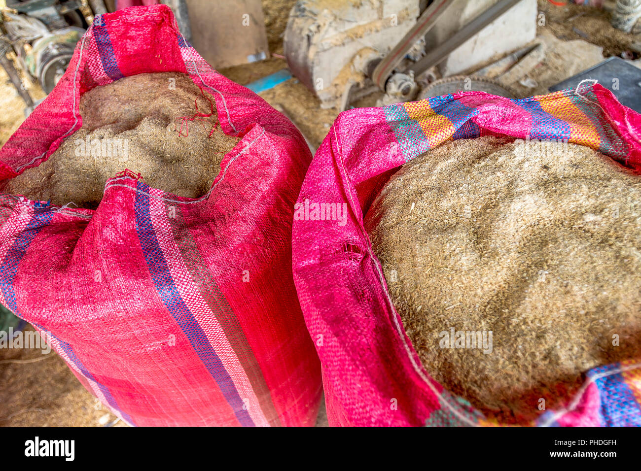 Bags of rice after husk machine removed outer shell Stock Photo - Alamy