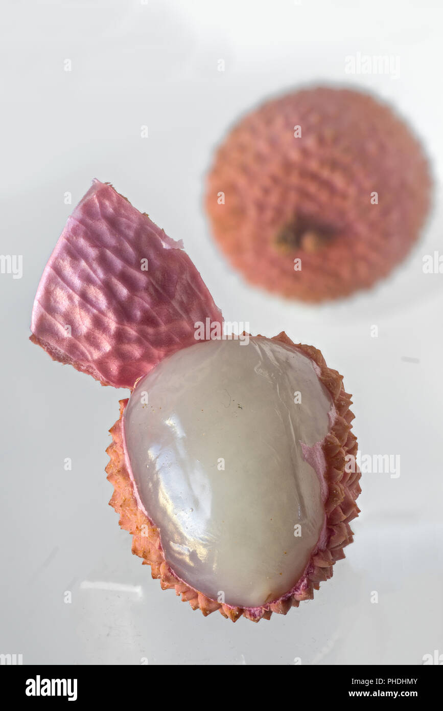 Lychees, partly peeled, isolated Stock Photo - Alamy