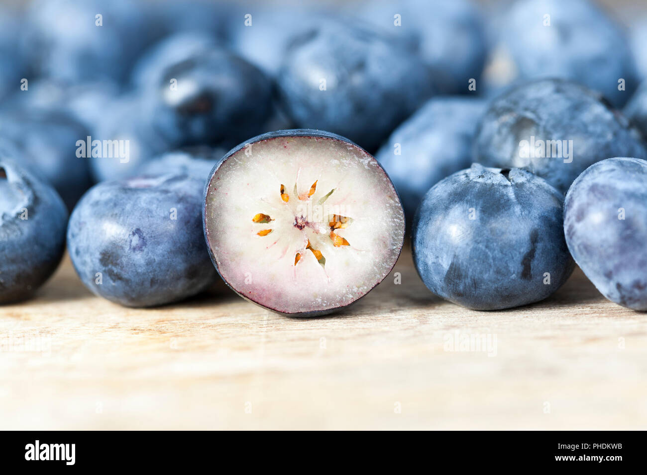 ripe blueberry berries close-up, one of the berries is cut into half ...