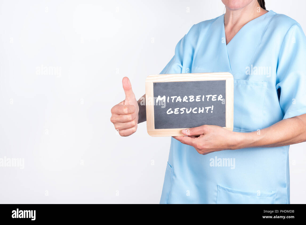 Doctor with signboard employee wanted Stock Photo - Alamy